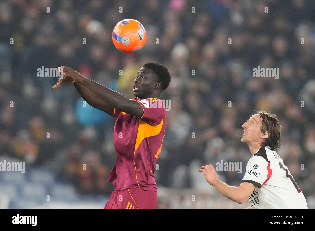 Roma's Robinio Vaz, left, and AC Milan's Luka Modric challenge for the ...