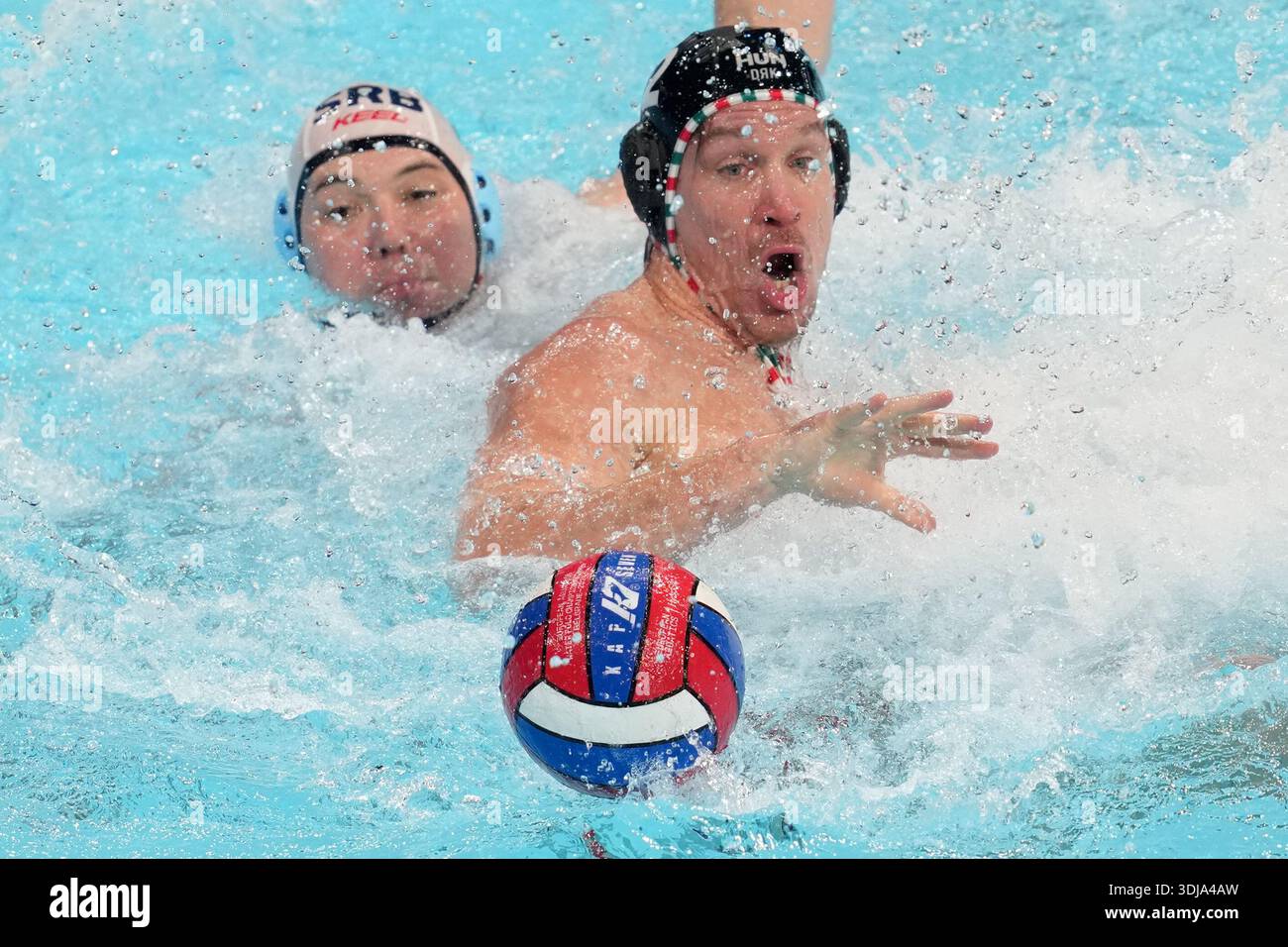 Hungary's Daniel Angyal, right, challenges for the ball with Serbia's ...