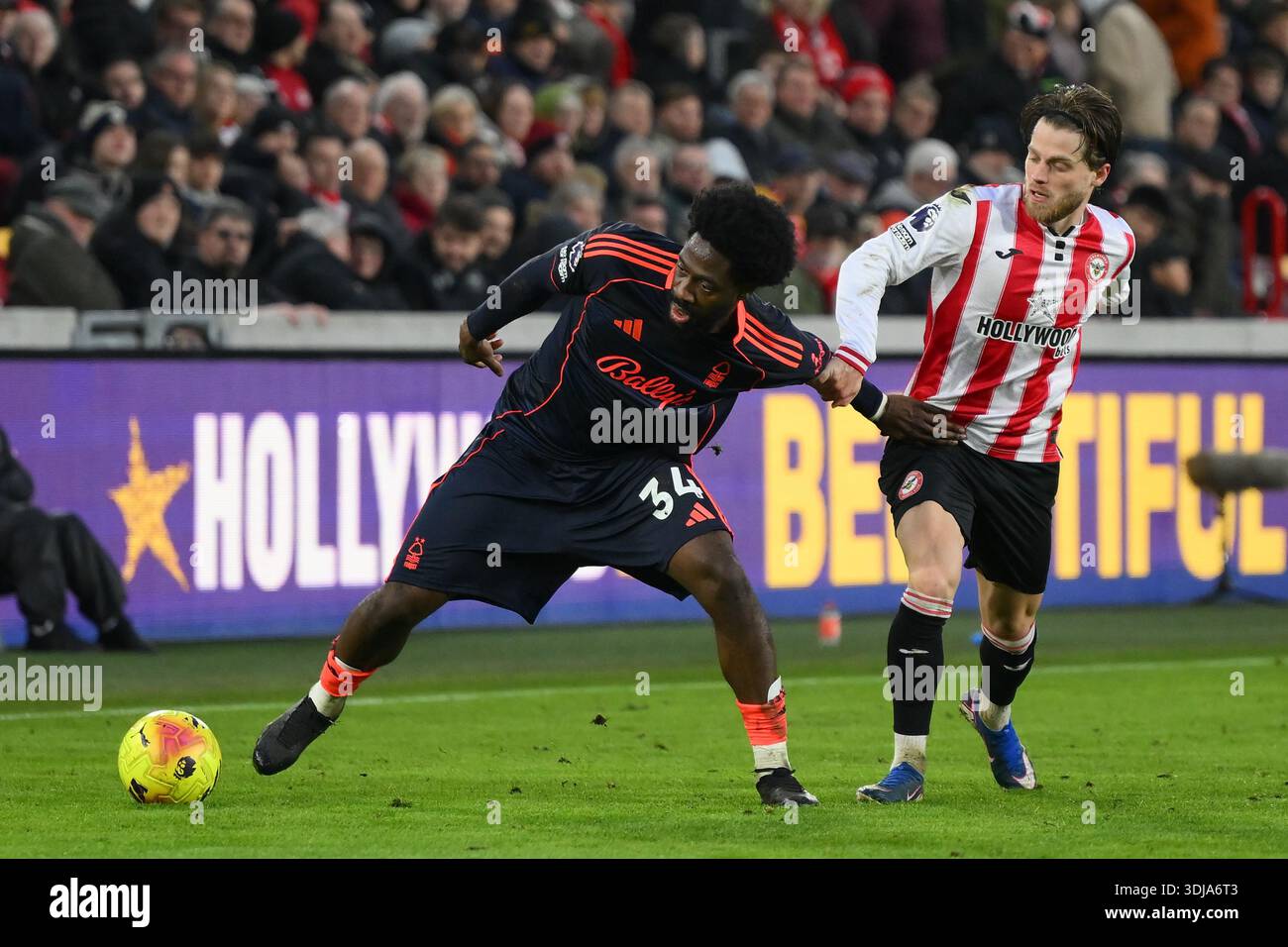 Ola Aina of Nottingham Forest battles with Mathias Jensen of Brentford ...