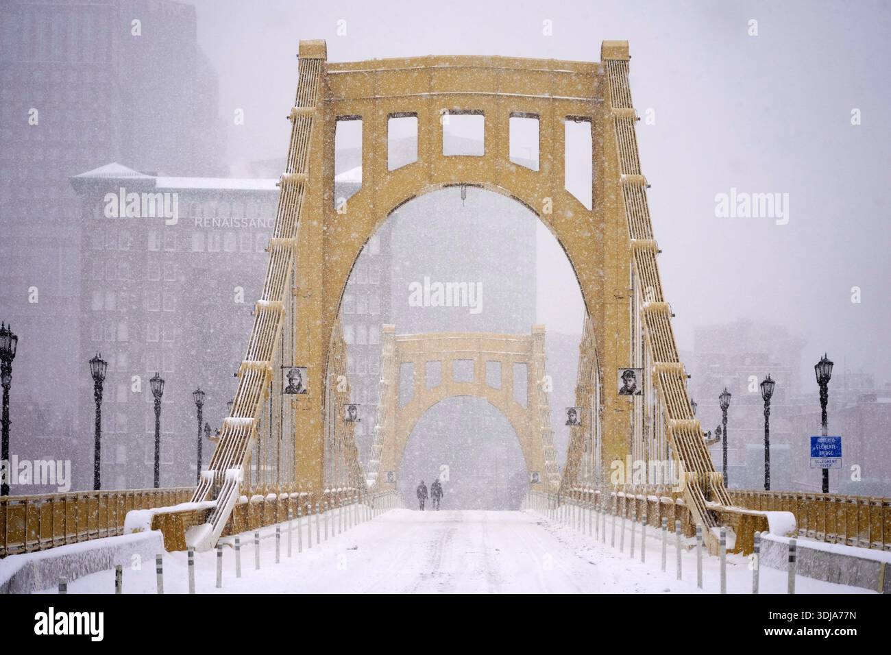 A couple walk across the Rachel Carson Bridge in downtown Pittsburgh ...