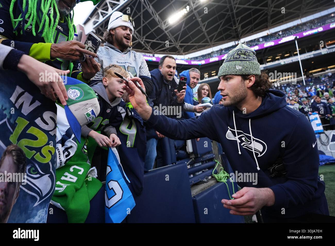 Seattle Seahawks tight end AJ Barner signs autographs for fans before ...