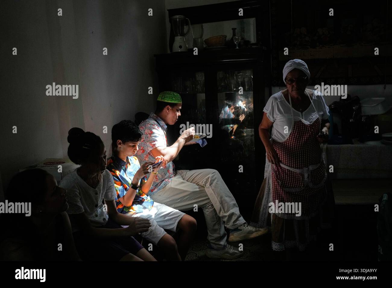 Santeria priests, also known as Babalawo, eat after a cleansing ritual ...