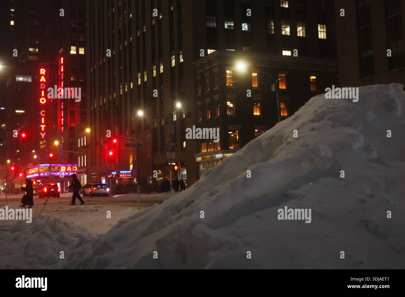 Pedestrians cross the street near Radio City Music Hall during a winter ...