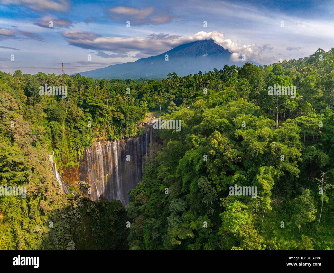Aerial View of Tumpak Sewu Waterfall with Mount Semeru Volcano in the ...
