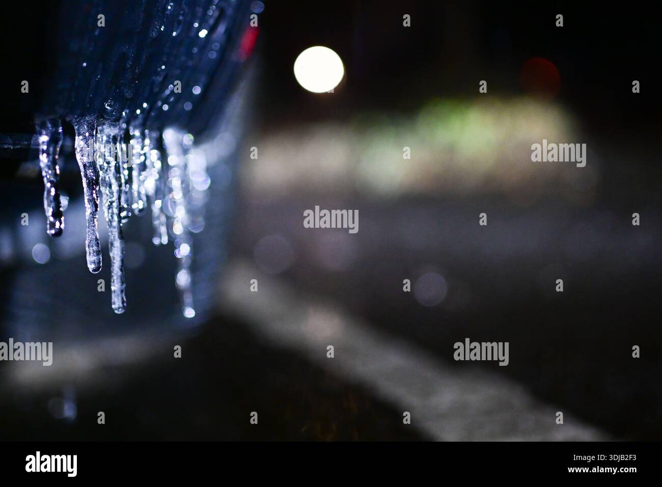 26 January 2026, Berlin: Icicles hang from a car during freezing rain ...