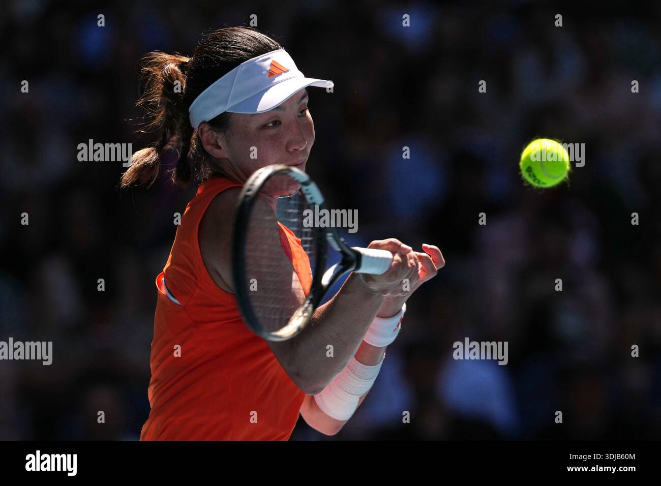 Wang Xinyu of China plays a forehand return to Amanda Anisimova of the ...