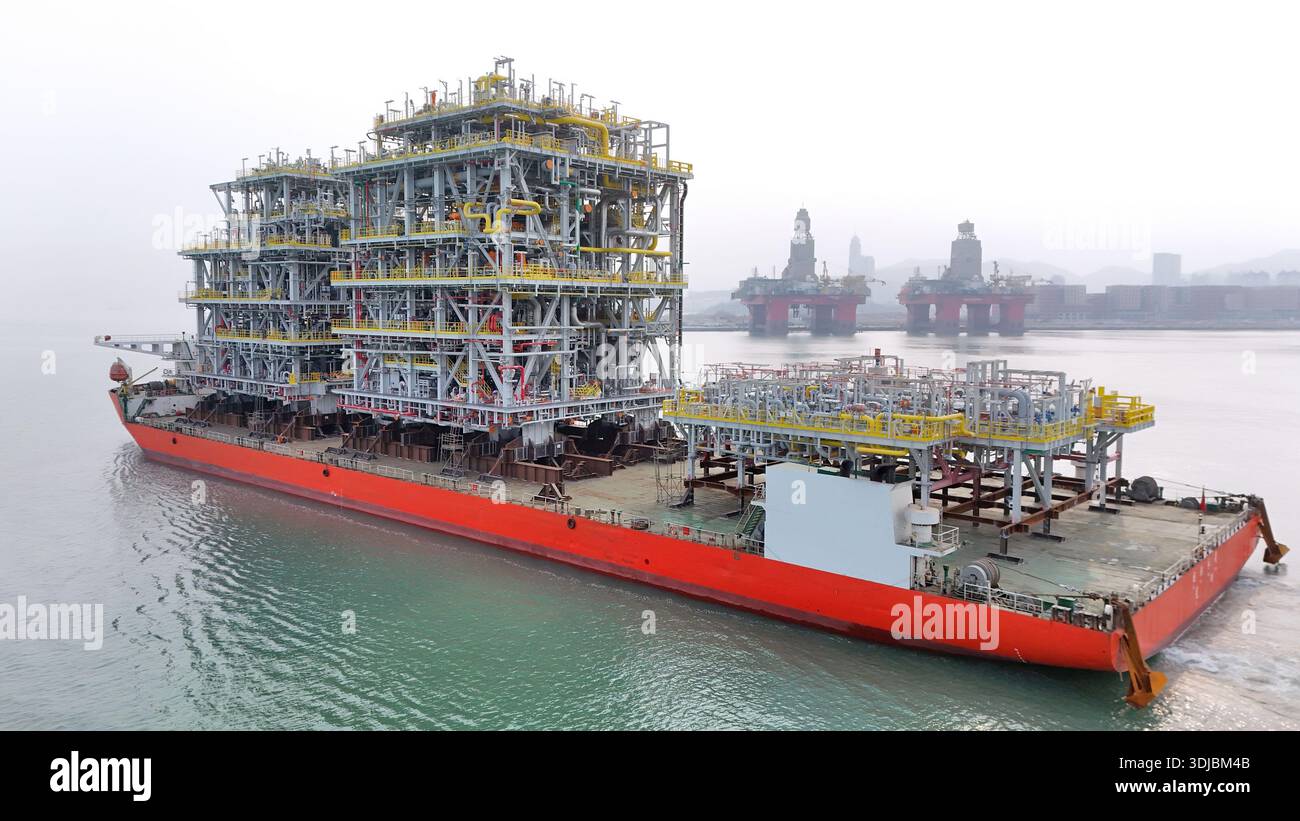 A deck barge carrying modules for a domestically built floating ...