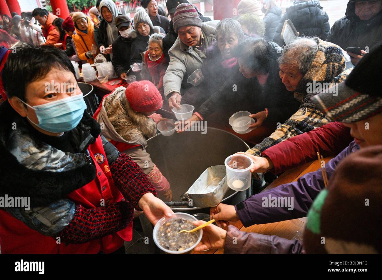 People line up for the free and auspicious Laba porridge offered by ...