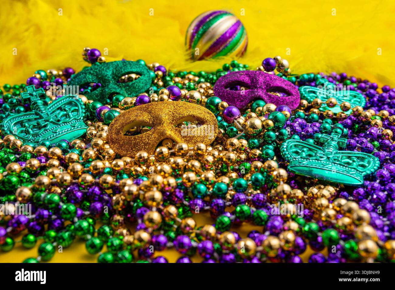 Mardi Gras beads in glittering yellow, green, purple, and gold ...