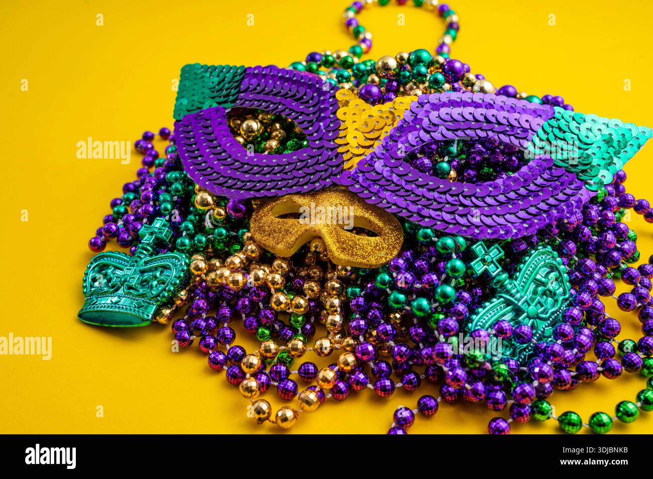 Mardi Gras beads in glittering yellow, green, purple, and gold ...