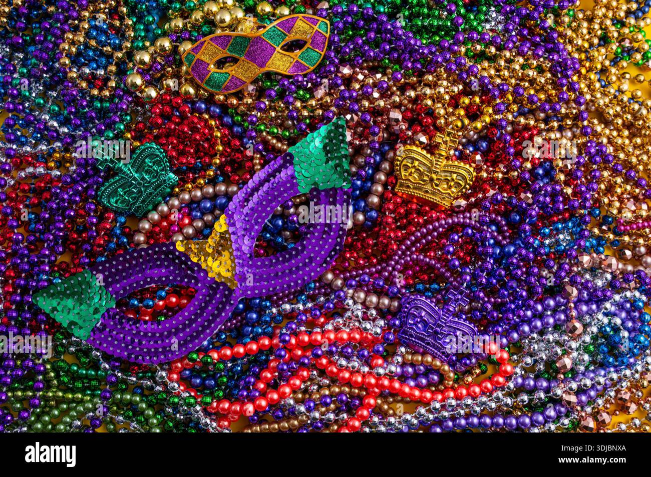 Mardi Gras beads in glittering yellow, green, purple, and gold ...