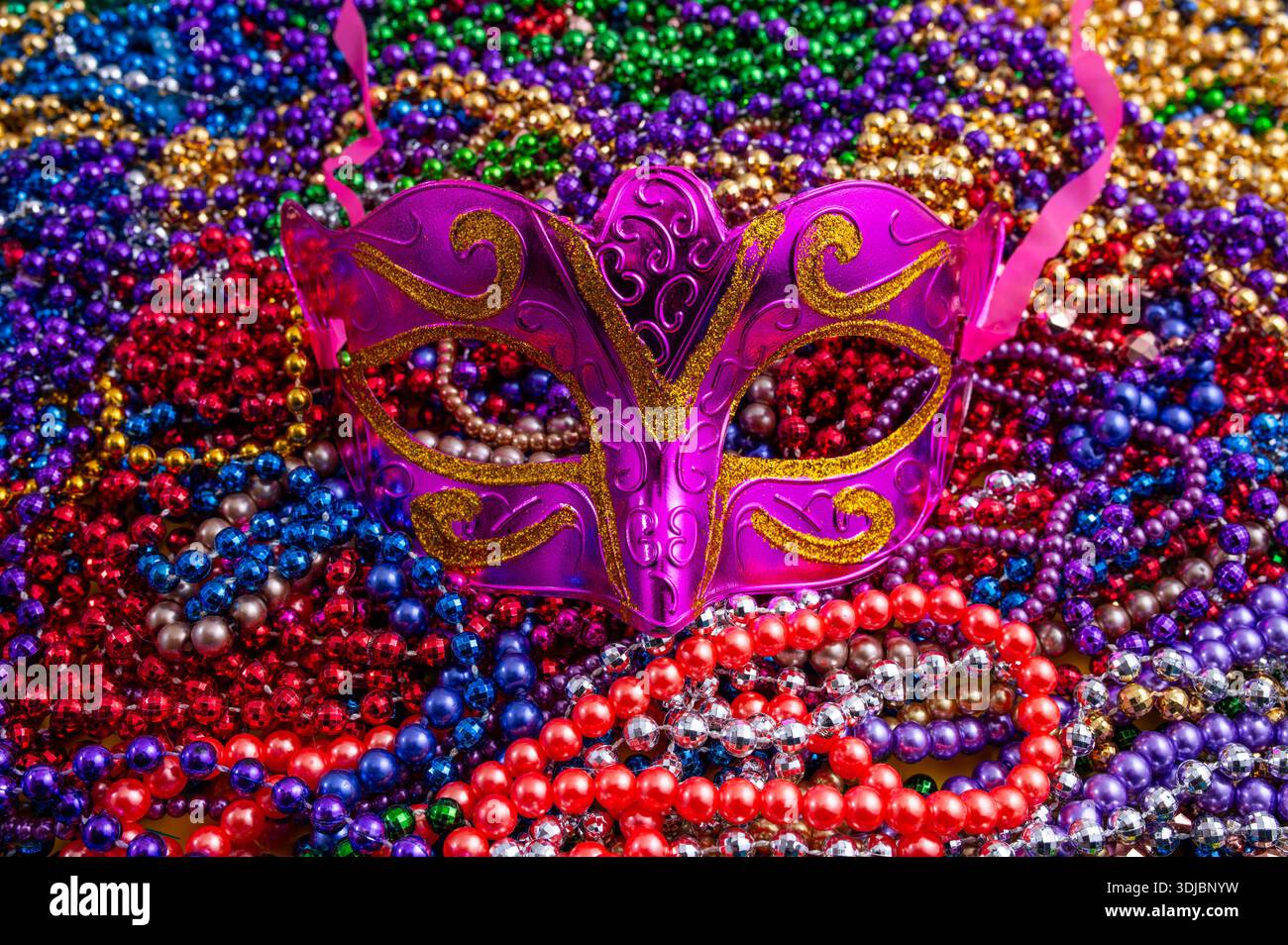 Mardi Gras beads in glittering yellow, green, purple, and gold ...