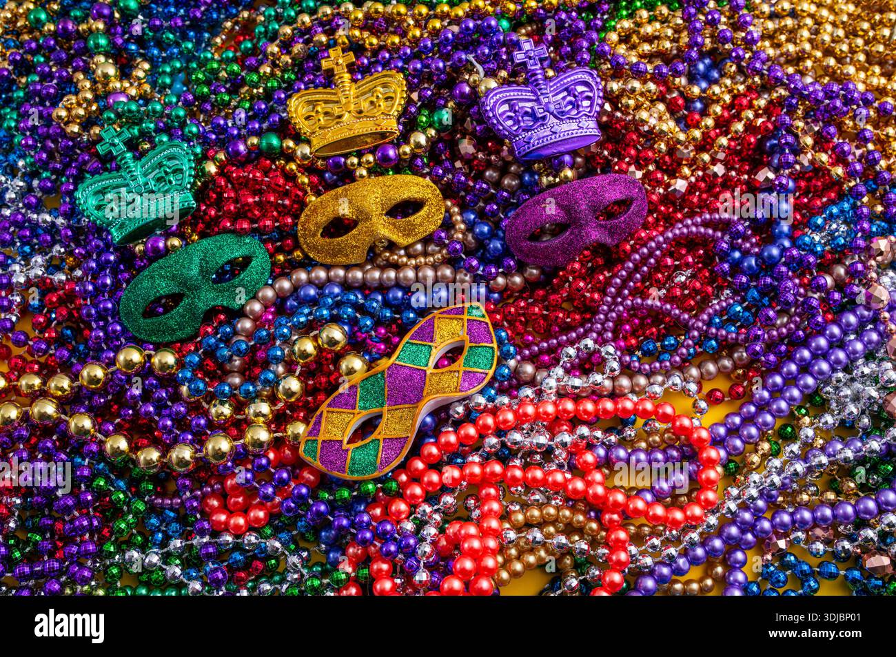 Mardi Gras beads in glittering yellow, green, purple, and gold ...