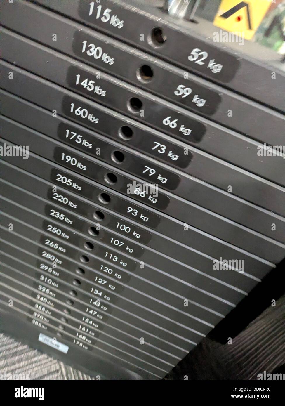 Heavy weights on a exercise machine for healthy living Stock Photo - Alamy