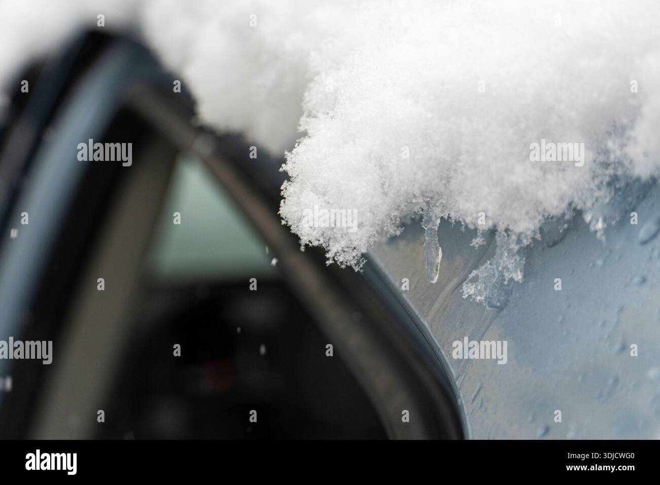 Car partially covered with fresh snow after winter snowfall. Cold ...