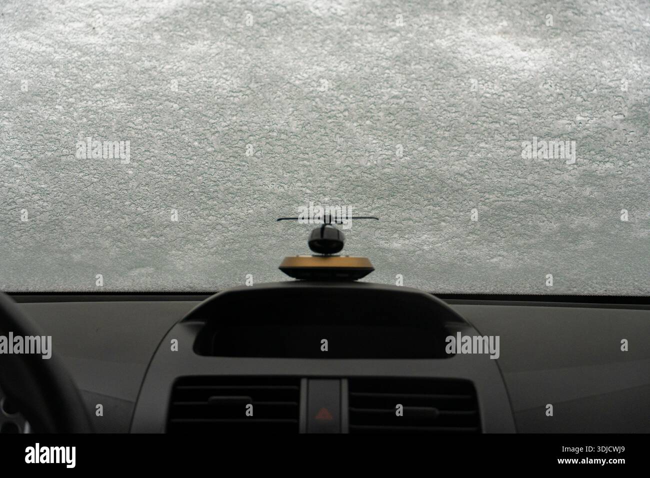 Interior view of a car with frosted windshield obscuring visibility ...