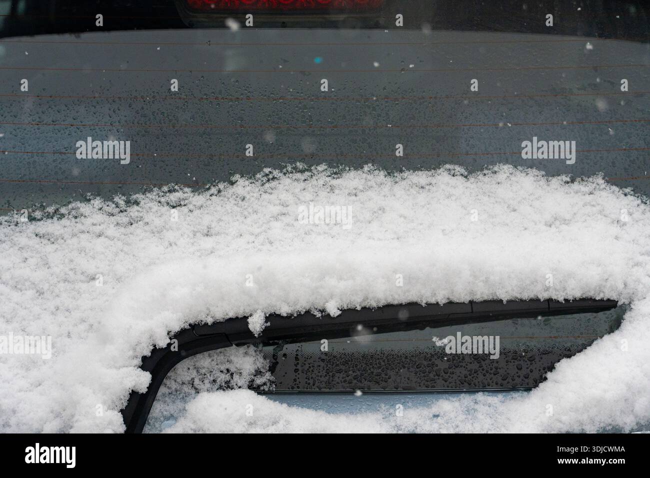 Car partially covered with fresh snow after winter snowfall. Cold ...
