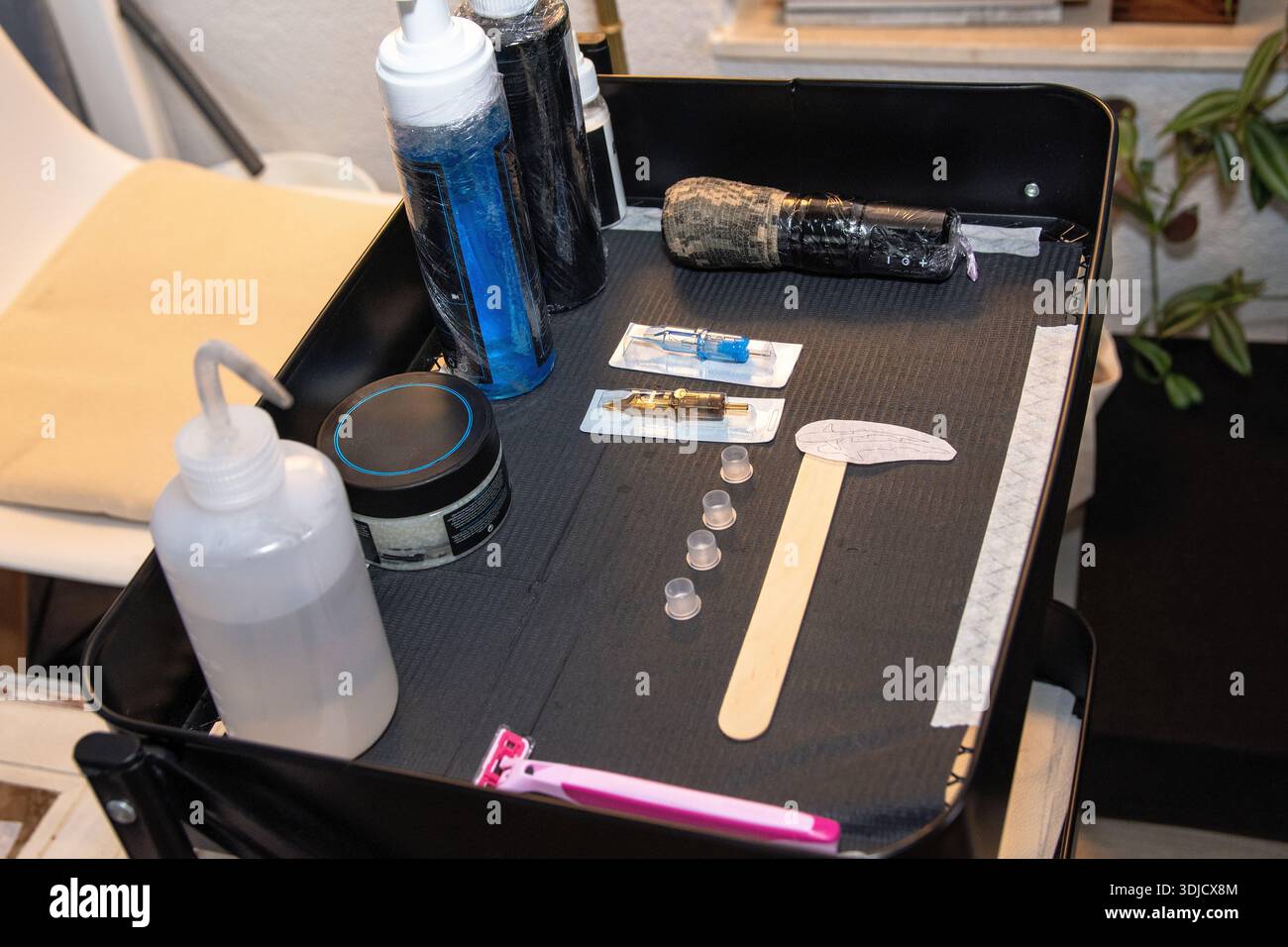 Tattoo artist workstation setup with sterilized equipment and inks ...