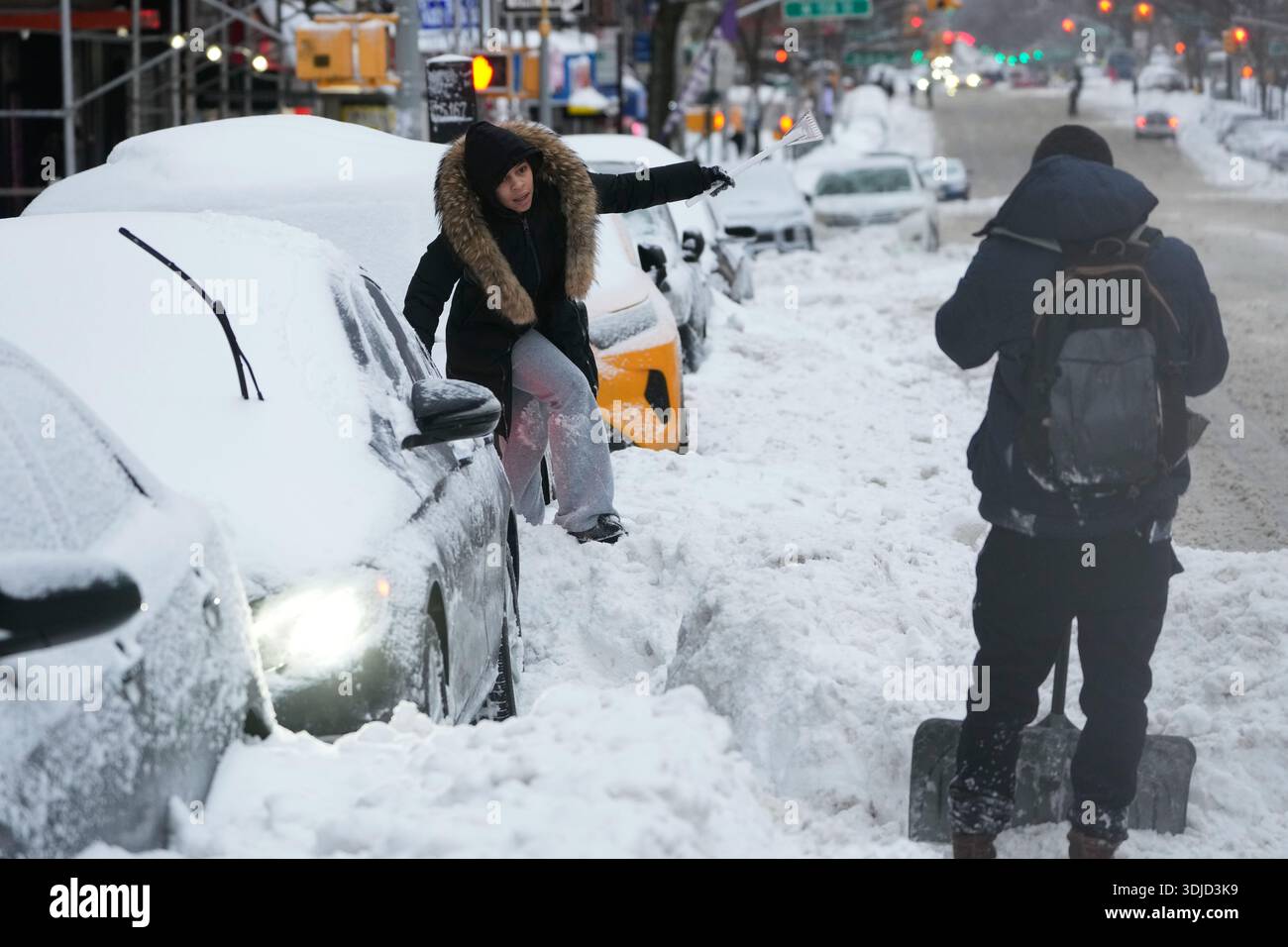 Jaylean Melvin tries to free her car from piled up snow in New York ...