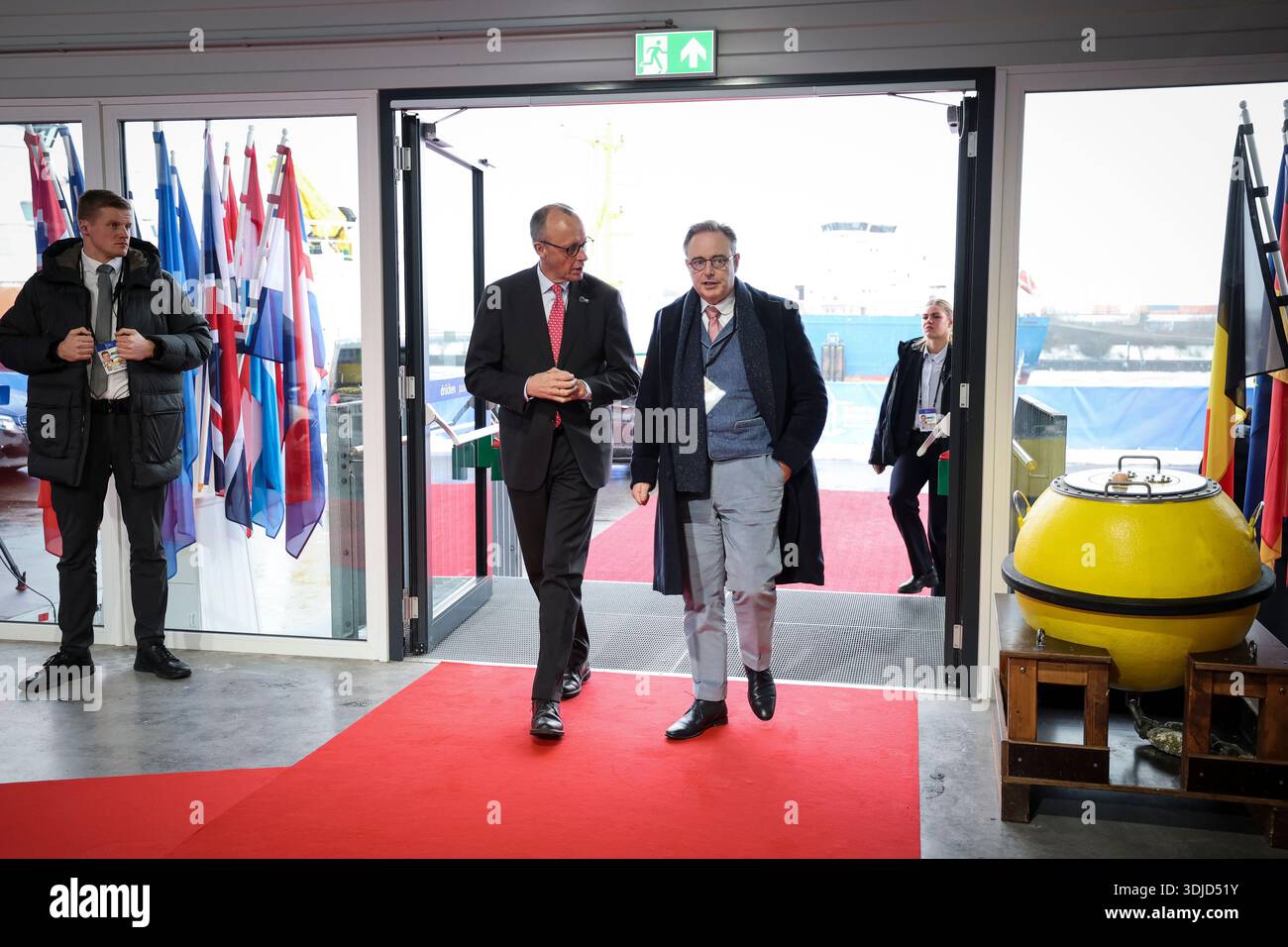 26 January 2026, Hamburg: Federal Chancellor Friedrich Merz (center l ...