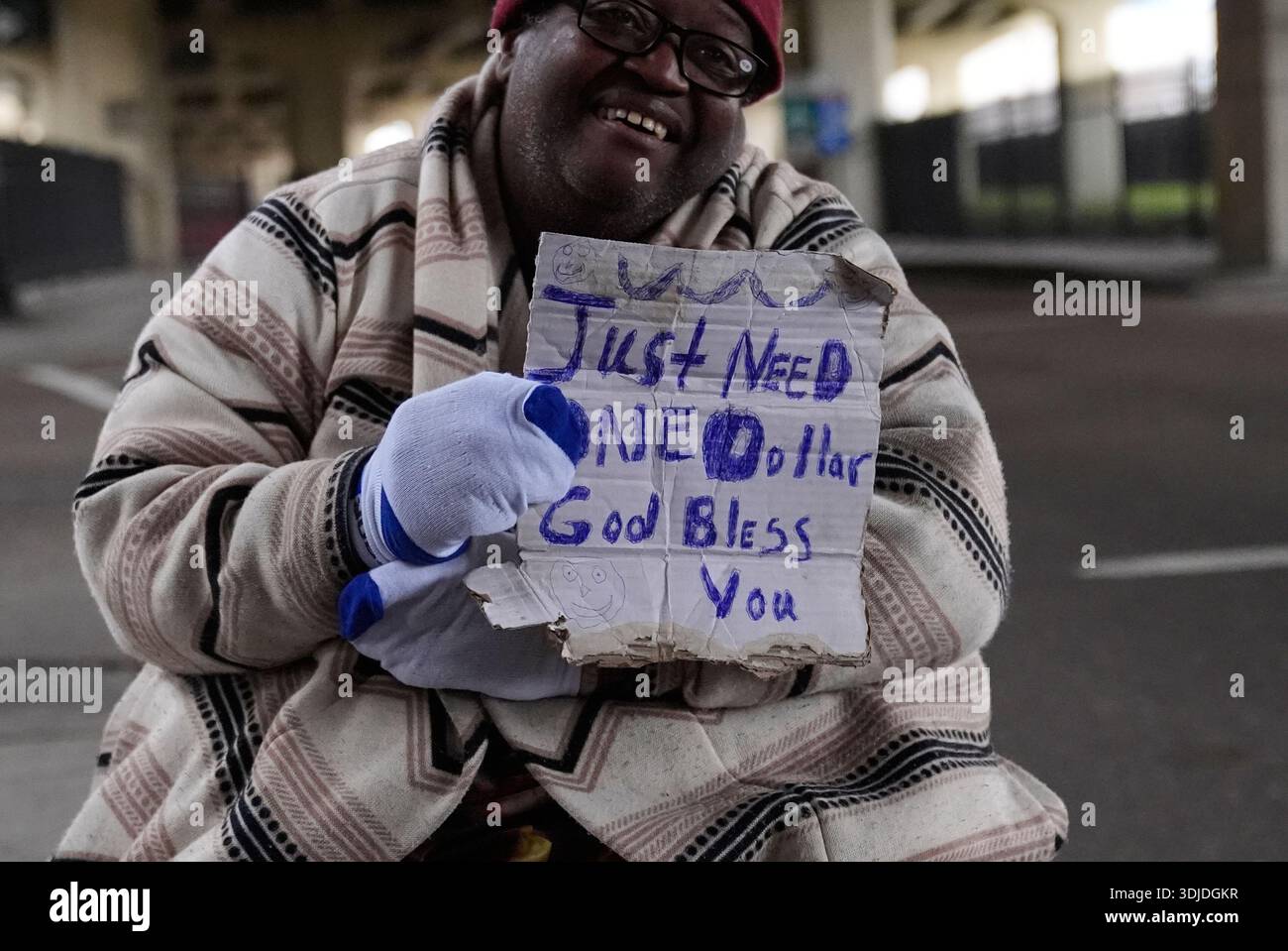 Victor Tate, who described himself as homeless, sits at an intersection ...