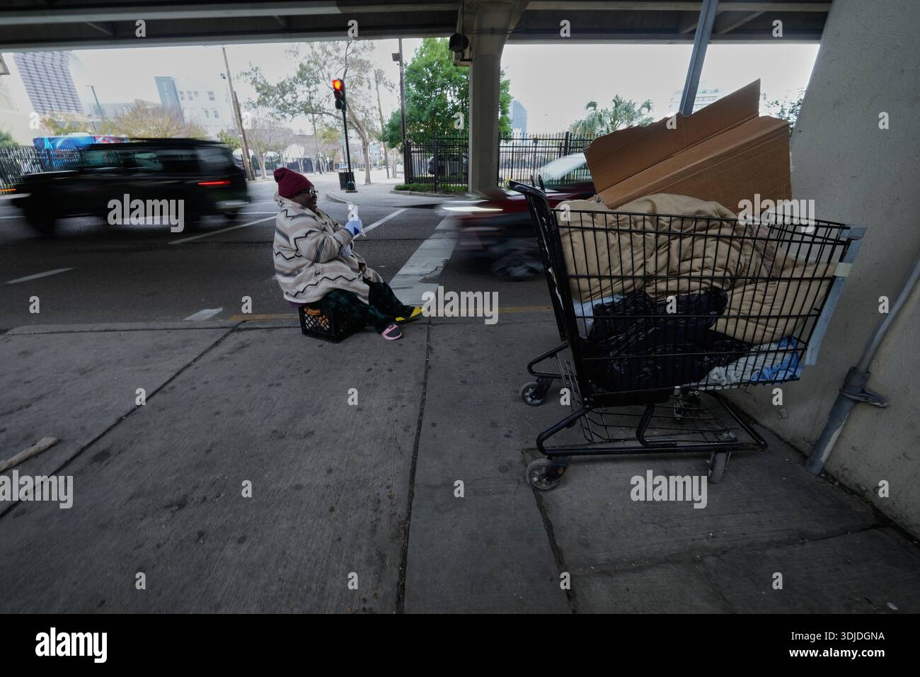 Victor Tate sits at an intersection after sleeping underneath an ...
