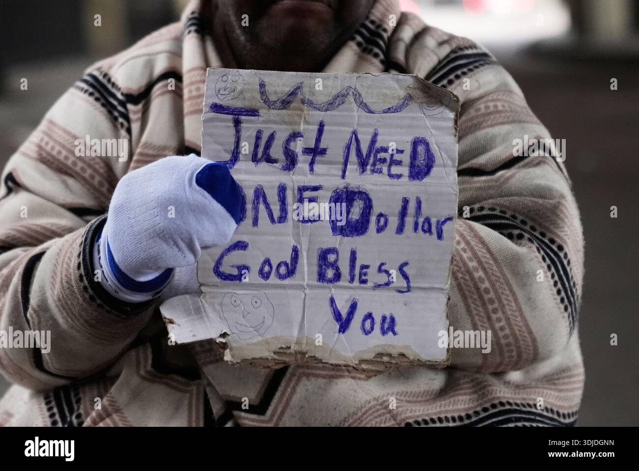 Victor Tate sits at an intersection after sleeping underneath an ...
