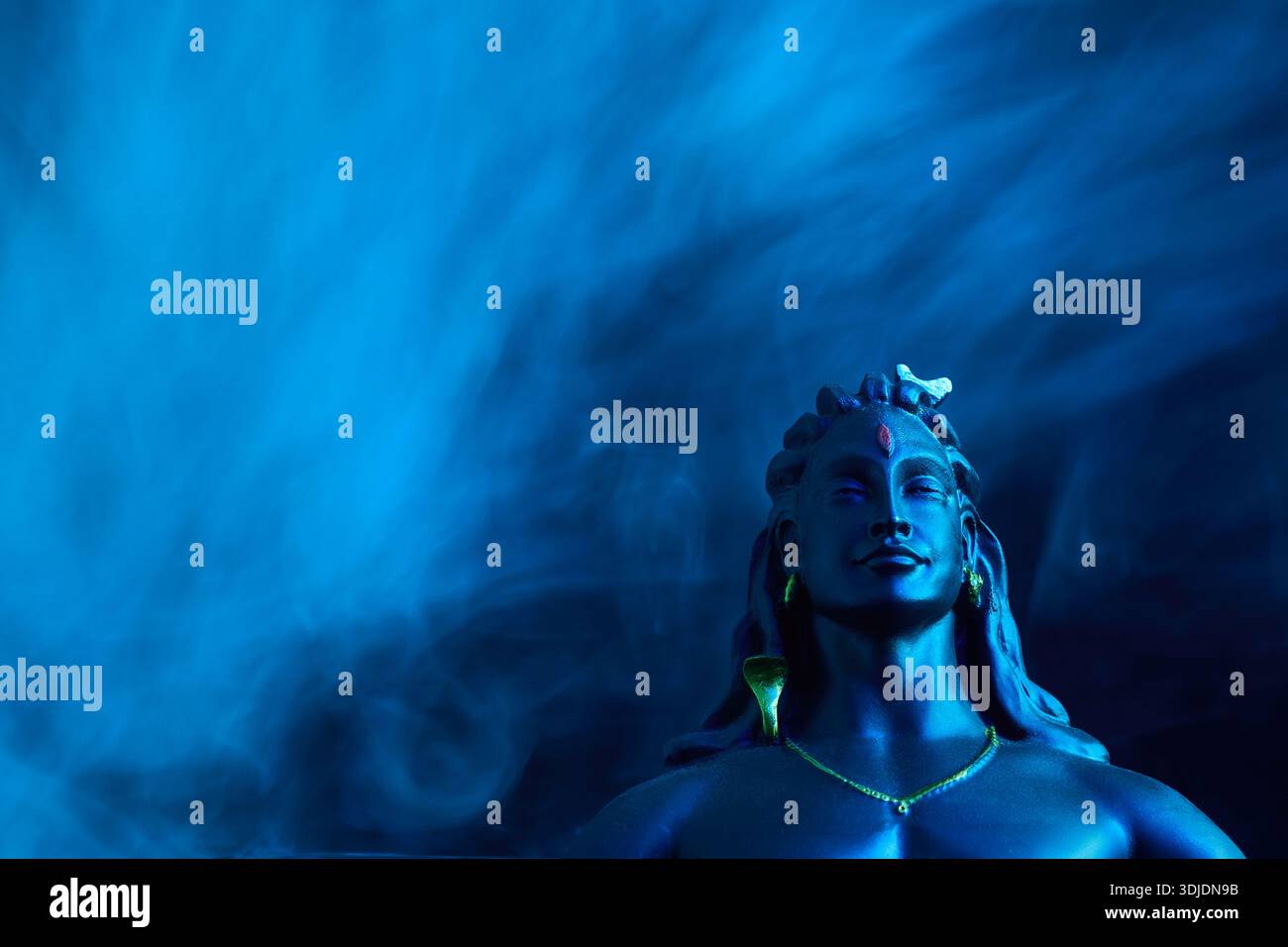 Maha Shivratri background. Lord shiva statue meditating in blue smoke ...