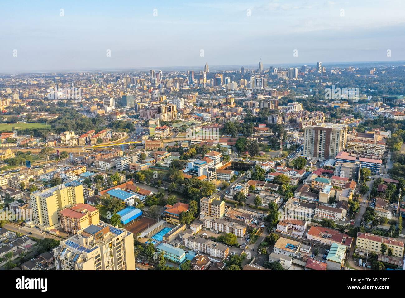 Aerial view of buildings and streets contrasting with the lush greenery ...