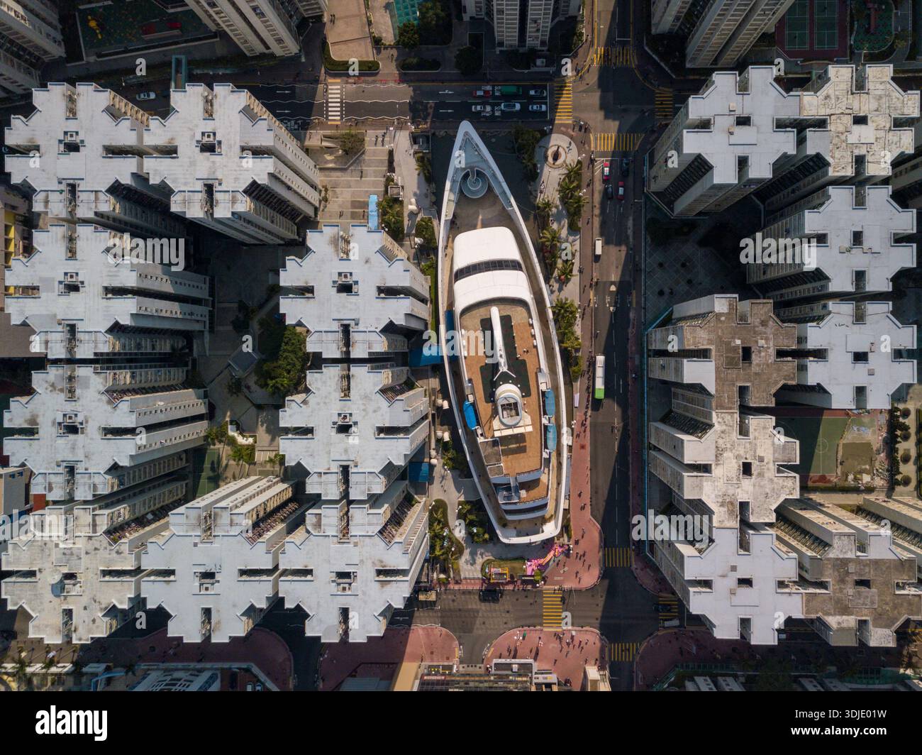 Aerial view of a massive yacht nestled between towering, geometric ...