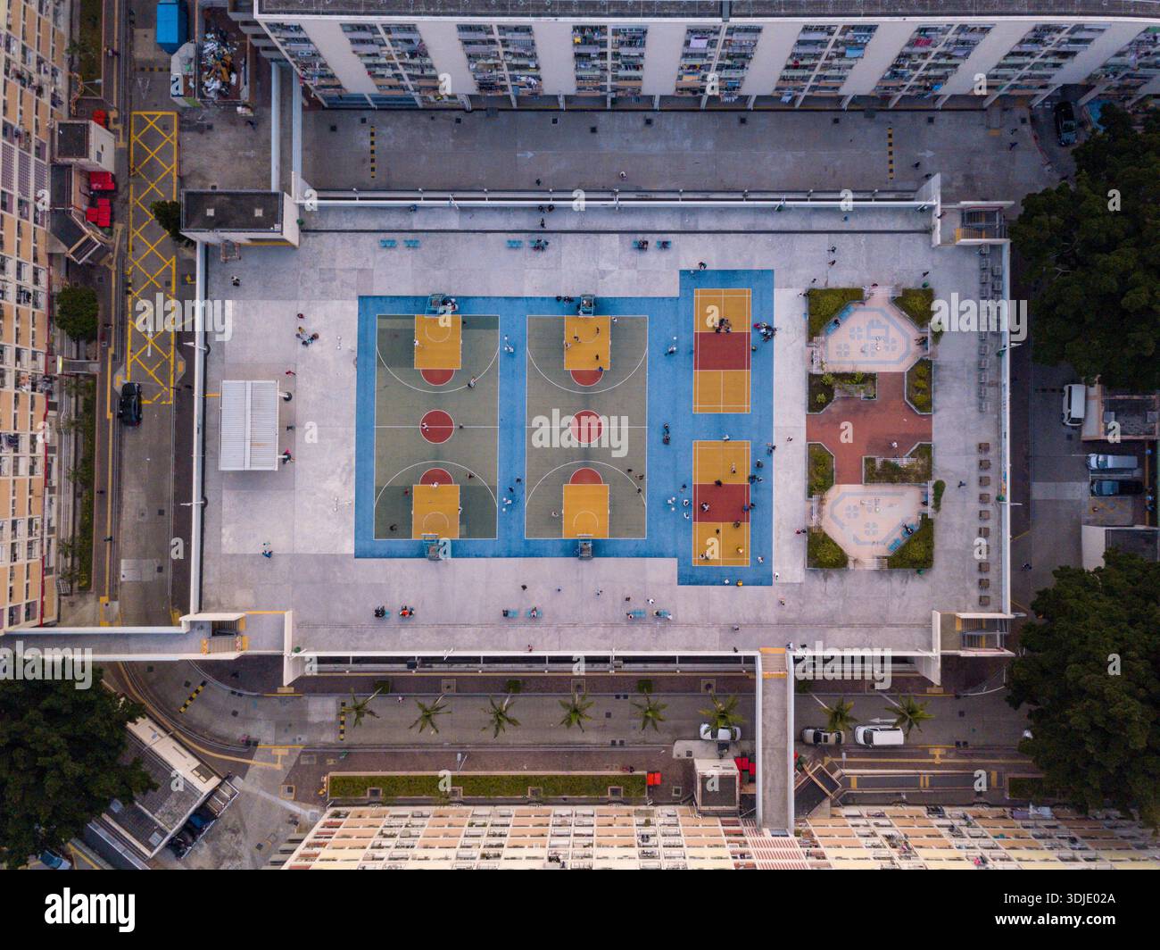 Aerial view of colorful basketball courts and a small garden nestled ...