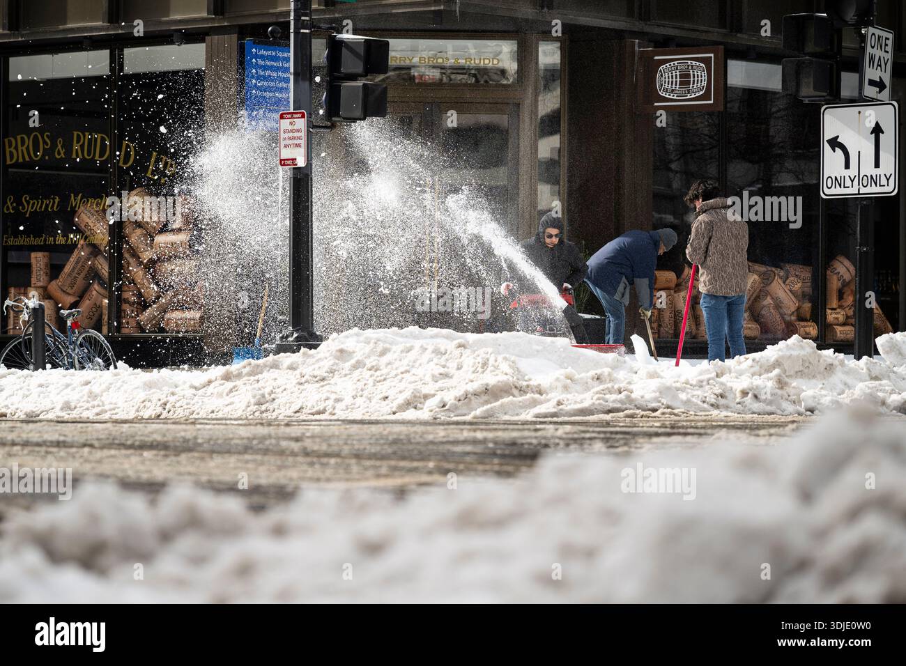 Workers clear snow after a major winter storm, in downtown Washington ...