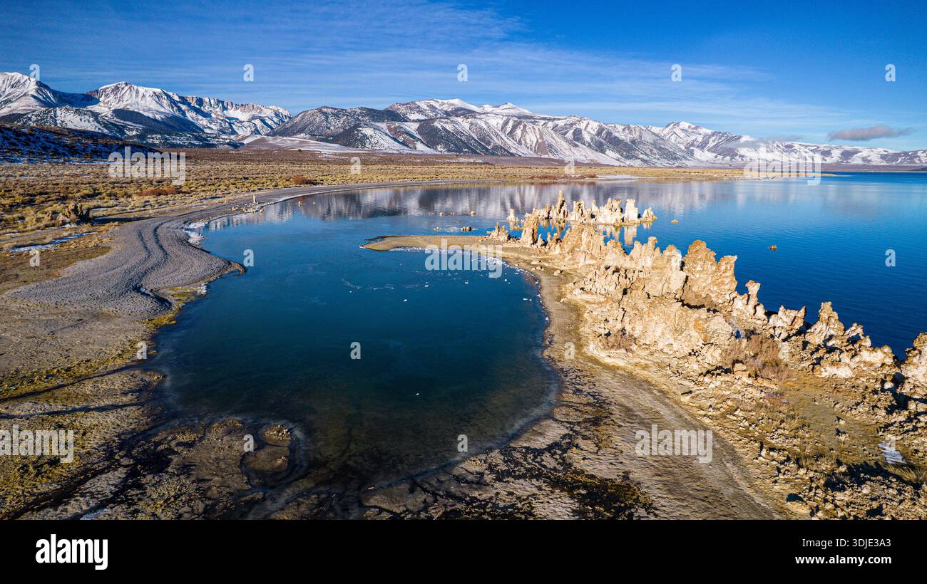 Aerial view of the tufa towers rising from the serene, reflective ...