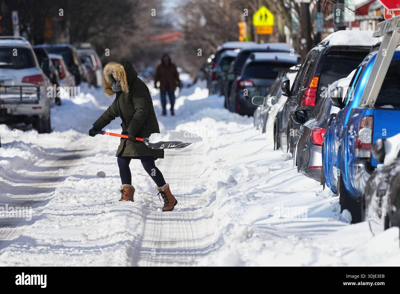 A person clears snow in the aftermath of a winter storm in Philadelphia ...