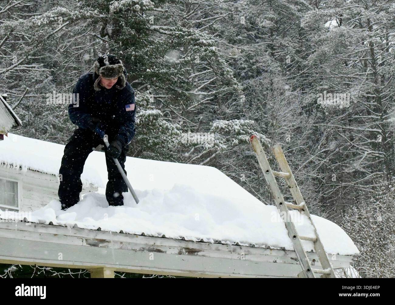 Jack Grimes shovels snow off his roof before it could do damage to the ...