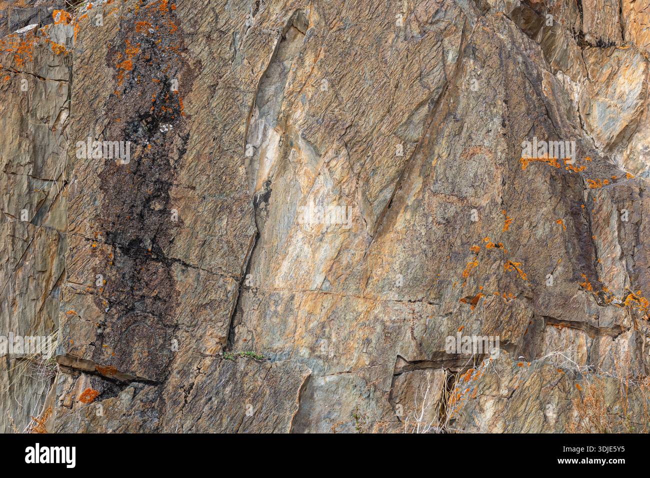 Rugged rock formation displays intricate textures and patterns under ...