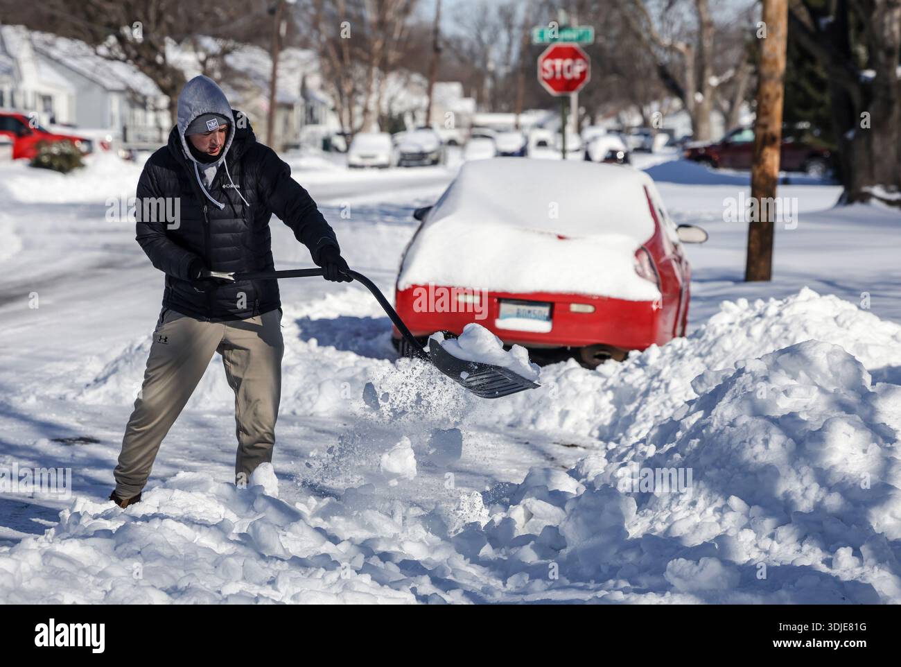 Keaton Fitzgerald uses a snow shovel to dig out of his driveway, Monday ...