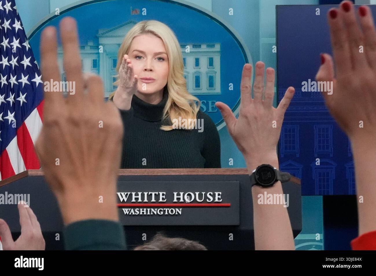 Reporters raise their hands to ask a question as White House press ...