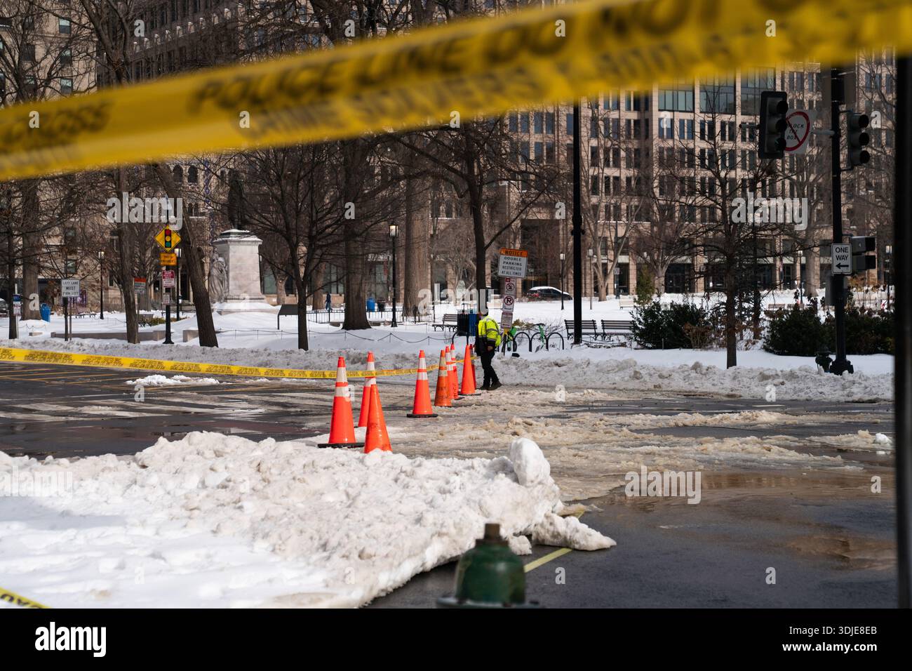 DC Water crews work around snow piles to repair a water main break ...