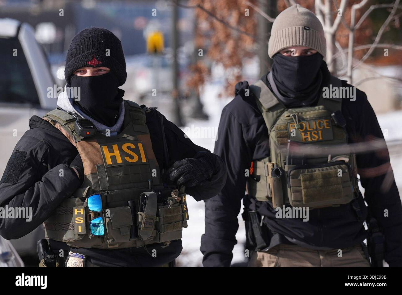 Federal agents stand outside of a property in Minneapolis, Monday, Jan ...