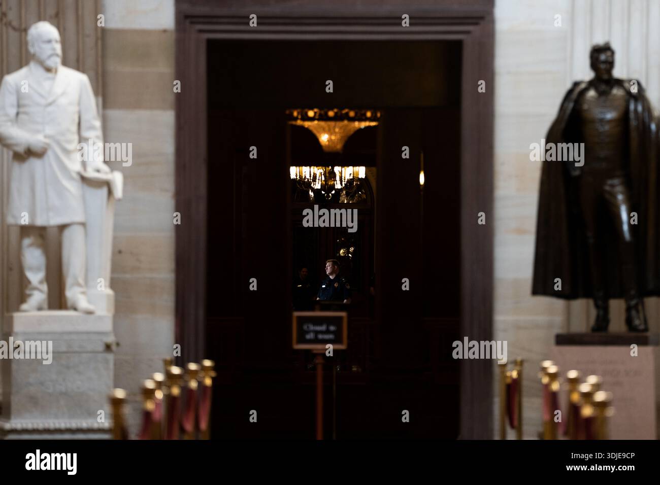 A Capitol Police Officer looks out a window, Monday, Jan. 26, 2026, in ...