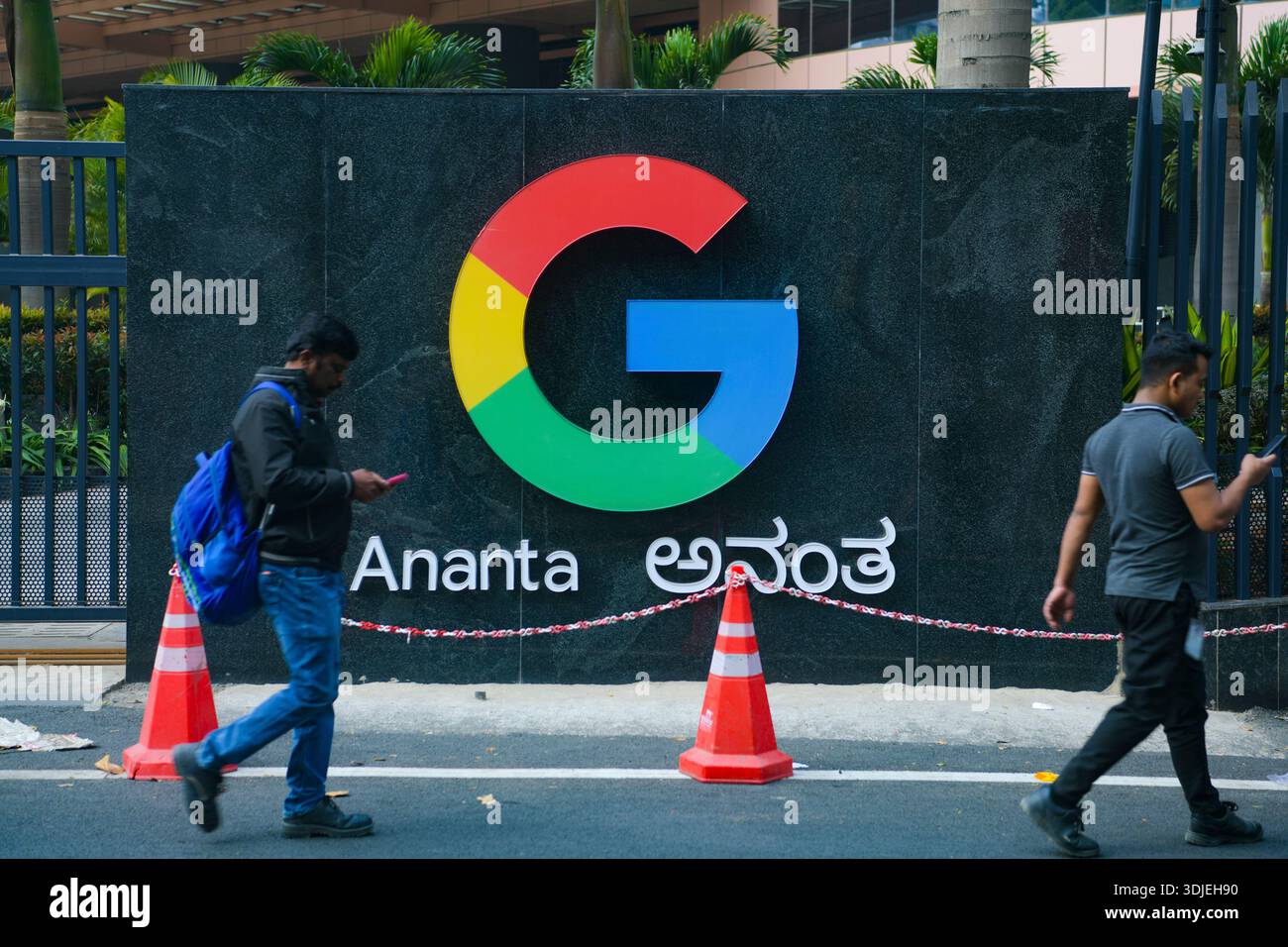 People walk pastthe Google 'G' emblem and the name 'Ananta' displayed ...