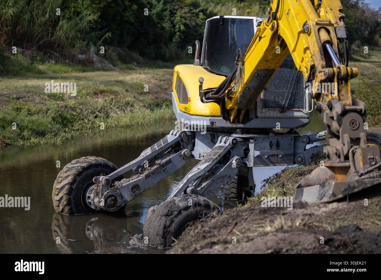 A wide technical shot of a yellow Menzi Muck M525x walking excavator ...