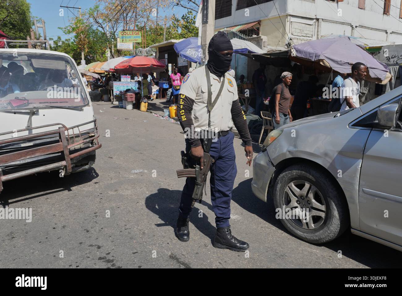 A police officer patrols a street in Port-au-Prince, Haiti, Monday, Jan ...