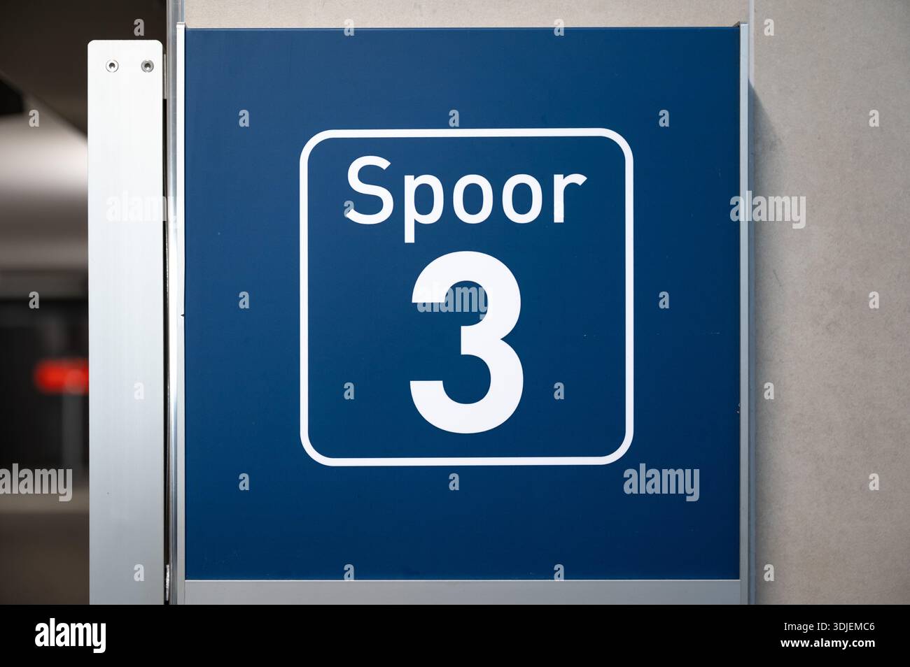 Sign indicating platform “track 3” at Denderleeuw station. Beyond its ...