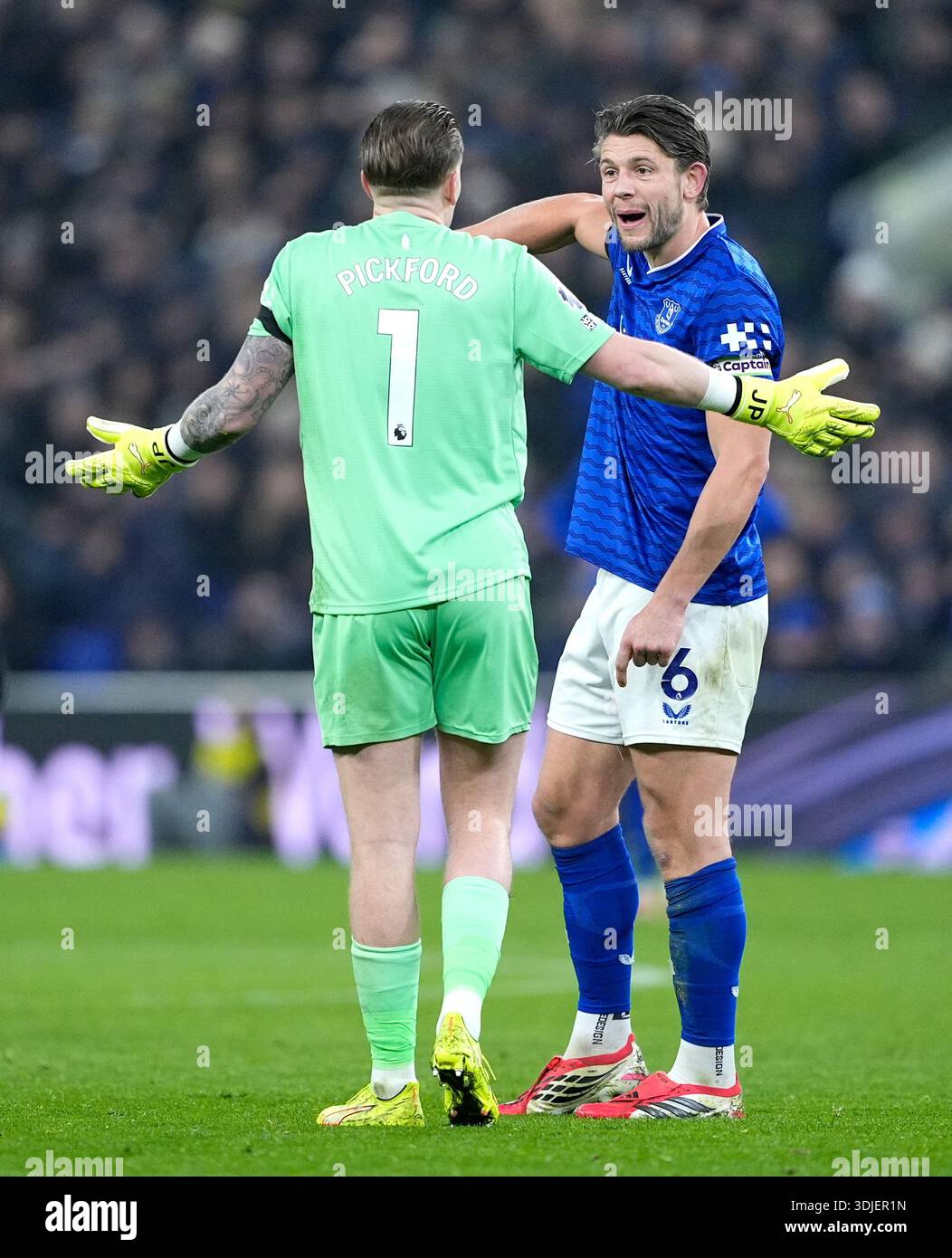 Everton's James Tarkowski speaks with goalkeeper Jordan Pickford during ...