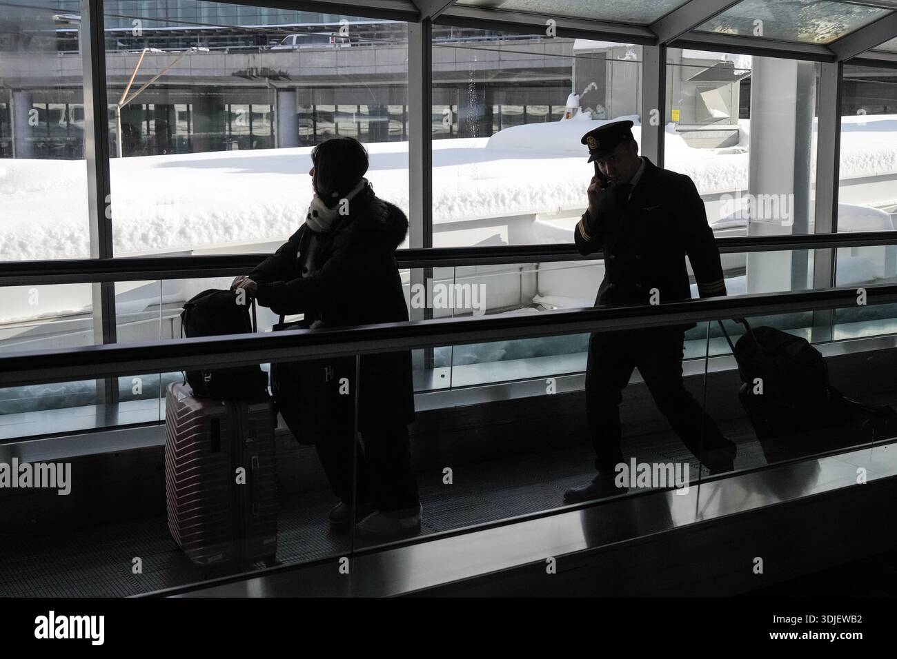 A passenger and a member of a flight crew walk through Toronto's ...