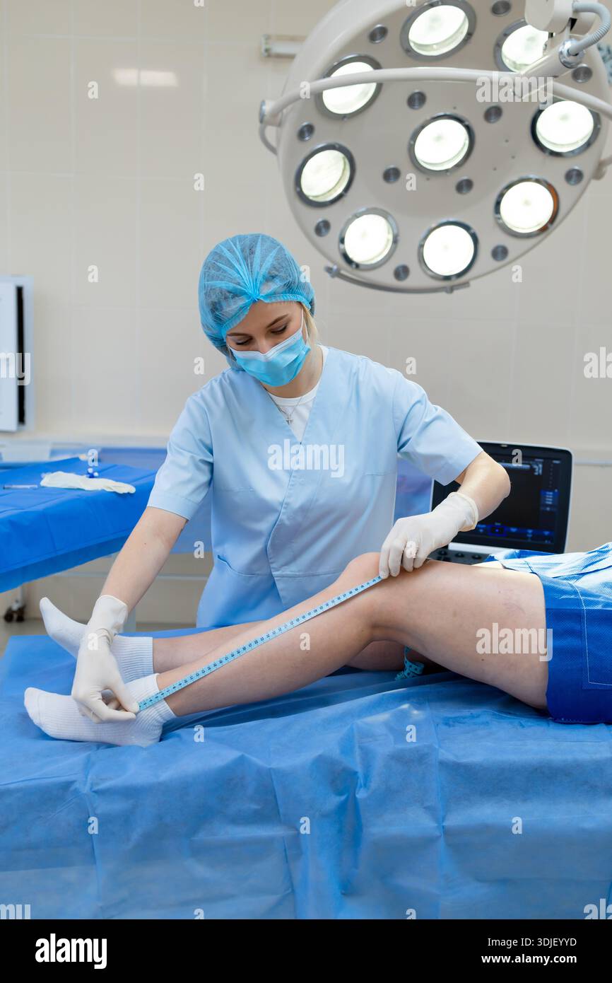 Leg measurement procedure conducted by vascular surgeon Stock Photo - Alamy