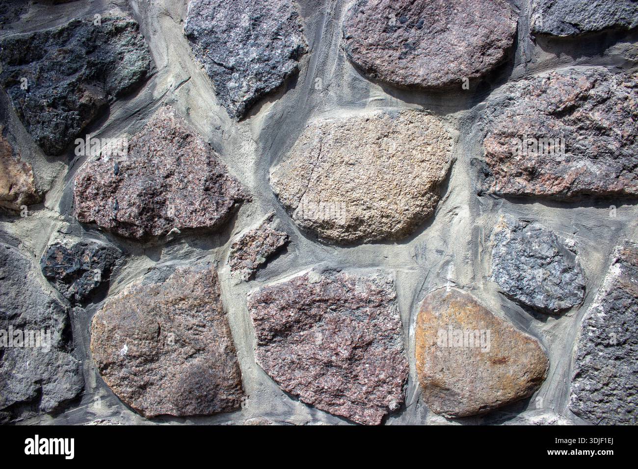 Close up of natural stone wall texture with rough granite blocks and ...
