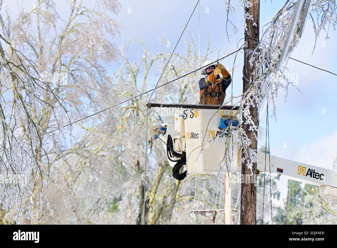 A lineman works to restore power in Oxford, Miss. on Monday, Jan. 26 ...